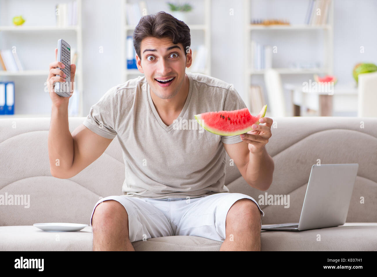 Man eating watermelon at home Stock Photo - Alamy