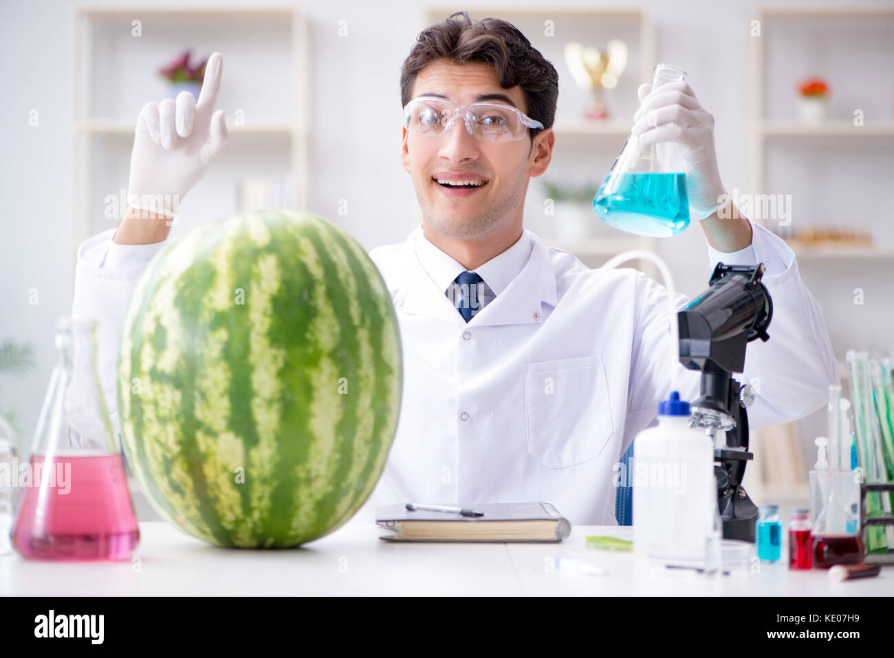 Scientist testing watermelon in lab Stock Photo - Alamy