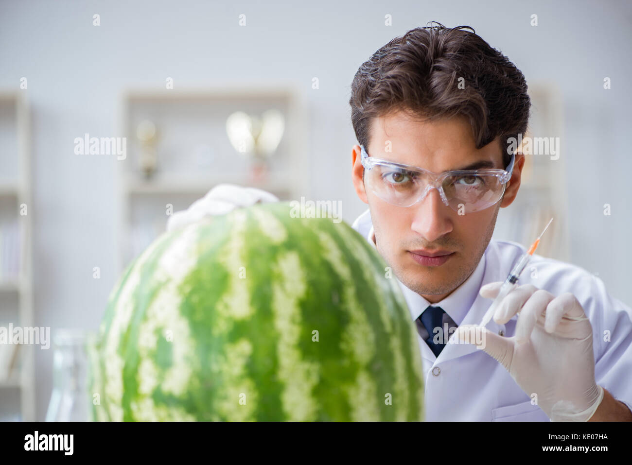 Scientist testing watermelon in lab Stock Photo - Alamy