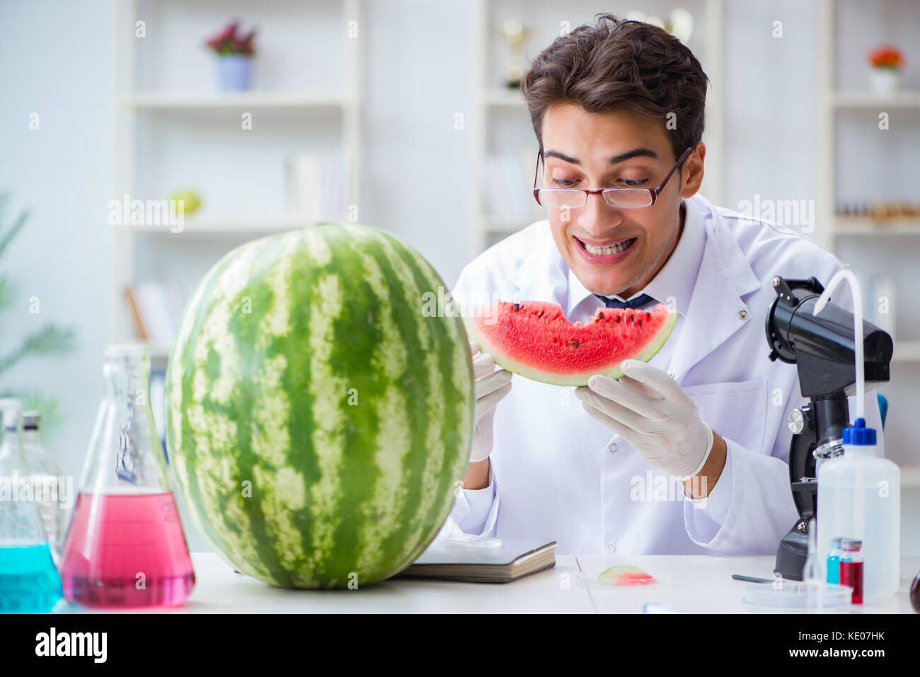 Scientist testing watermelon in lab Stock Photo - Alamy