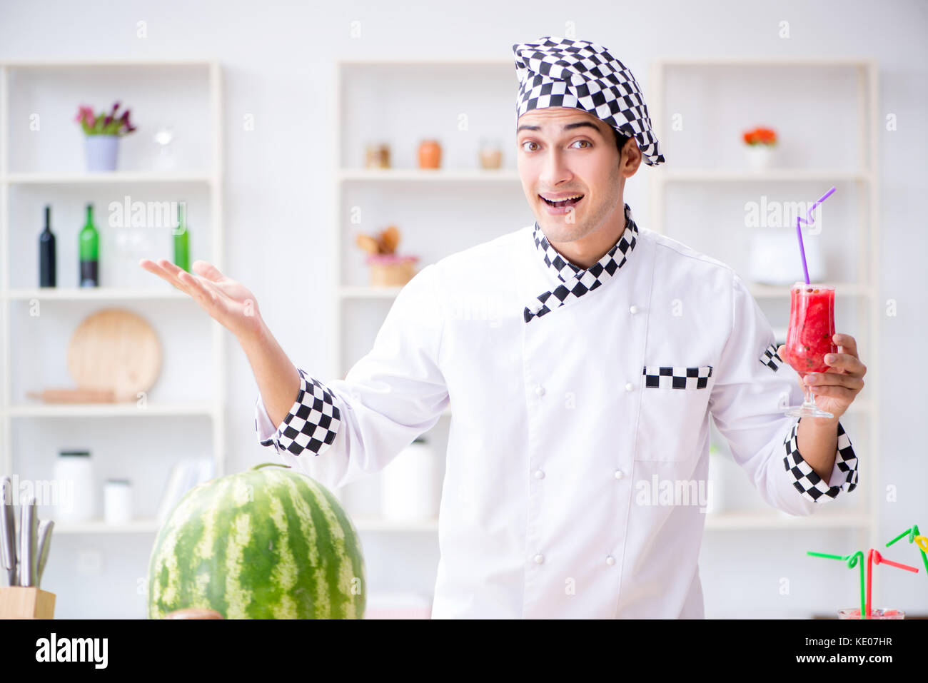 Male cook with watermelon in kitchen Stock Photo - Alamy