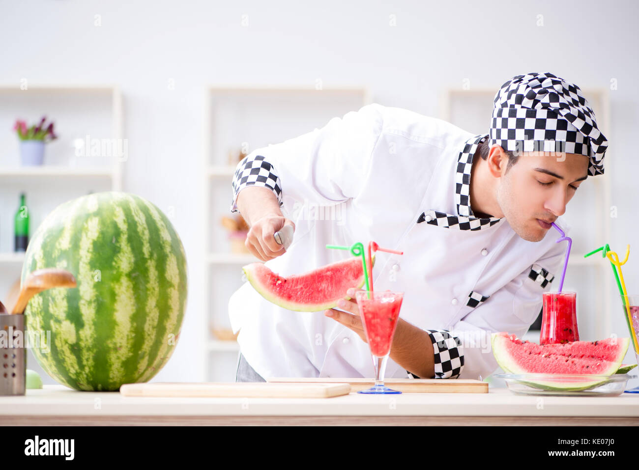 Male cook with watermelon in kitchen Stock Photo - Alamy