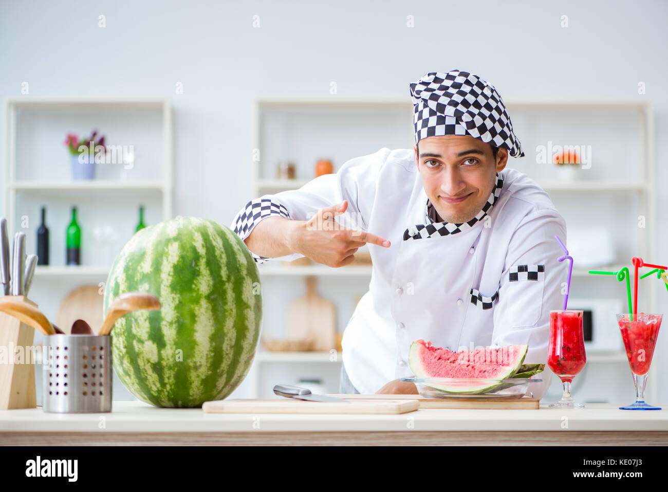 Male cook with watermelon in kitchen Stock Photo - Alamy