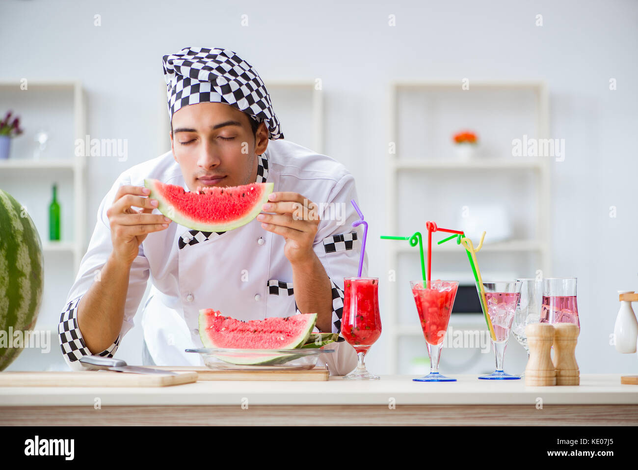 Male cook with watermelon in kitchen Stock Photo - Alamy