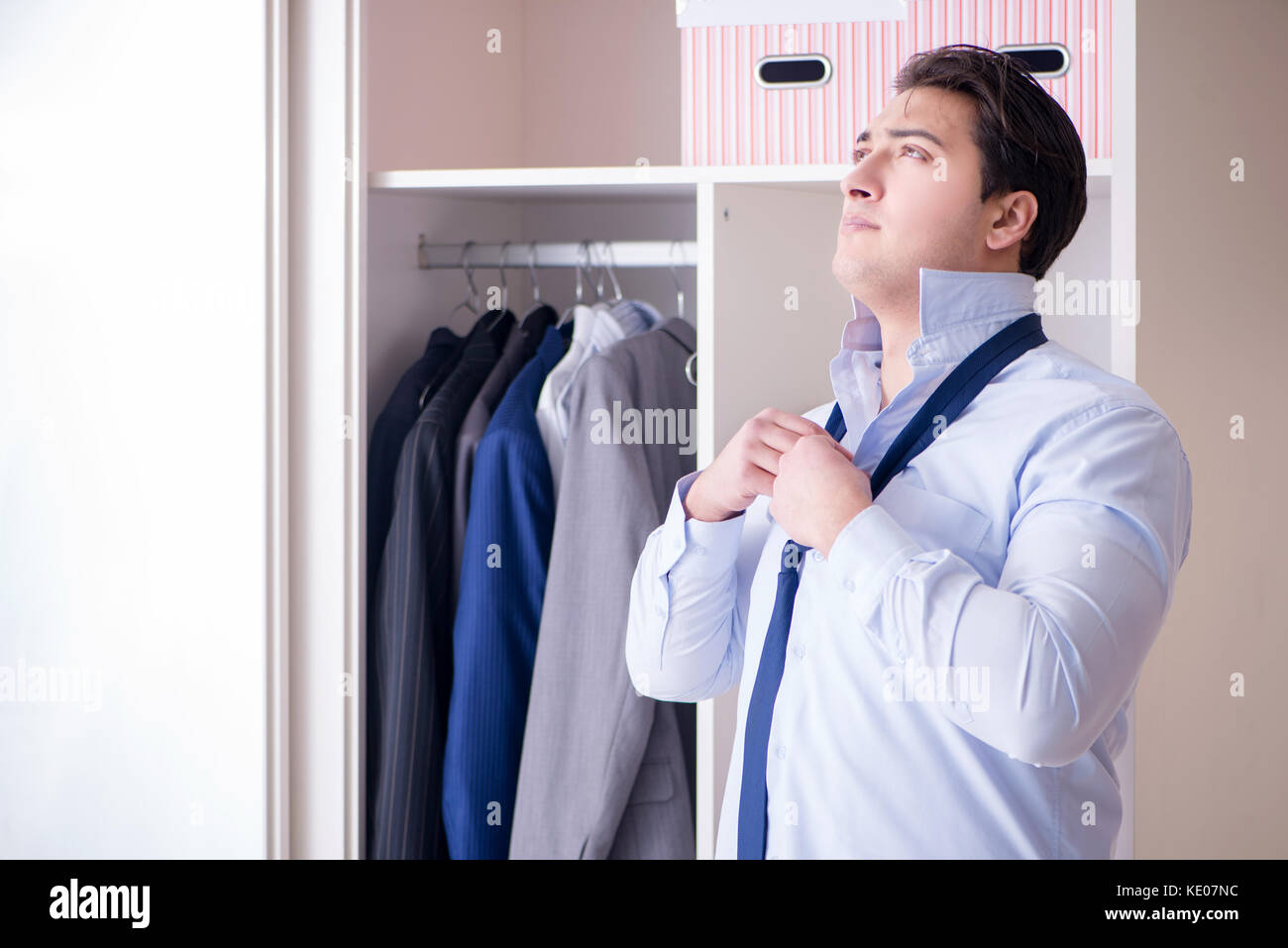 Young man businessman getting dressed for work Stock Photo - Alamy