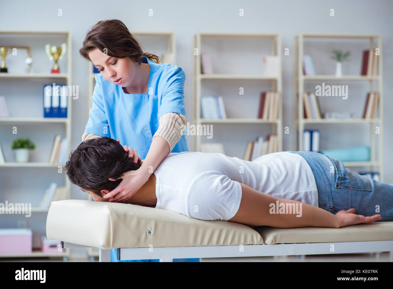 Female chiropractor doctor massaging male patient Stock Photo - Alamy