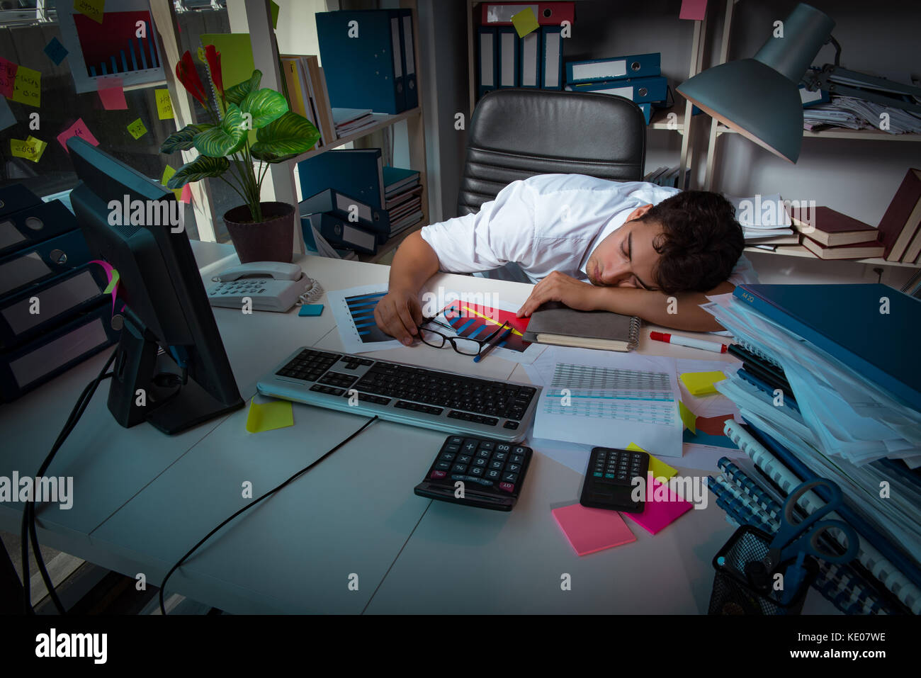 Man businessman working late hours in the office Stock Photo - Alamy