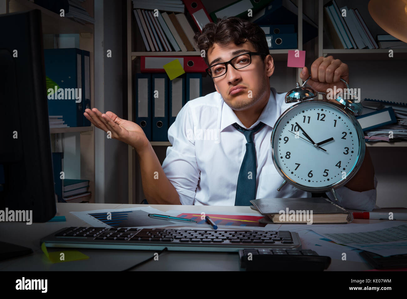 Man businessman working late hours in the office Stock Photo - Alamy