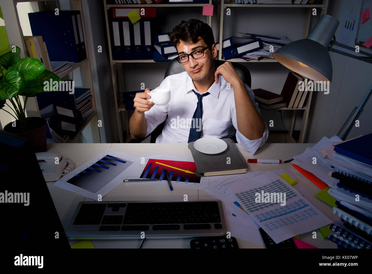 Man businessman working late hours in the office Stock Photo - Alamy