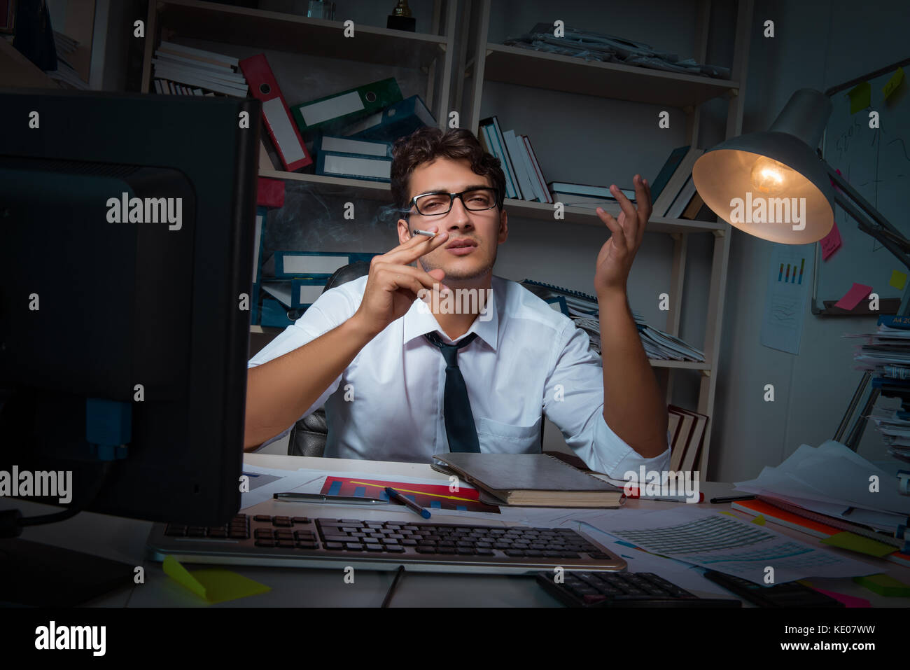 Man businessman working late hours in the office Stock Photo - Alamy