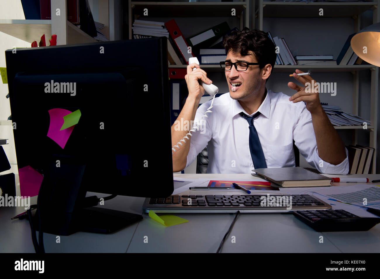 Man businessman working late hours in the office Stock Photo - Alamy