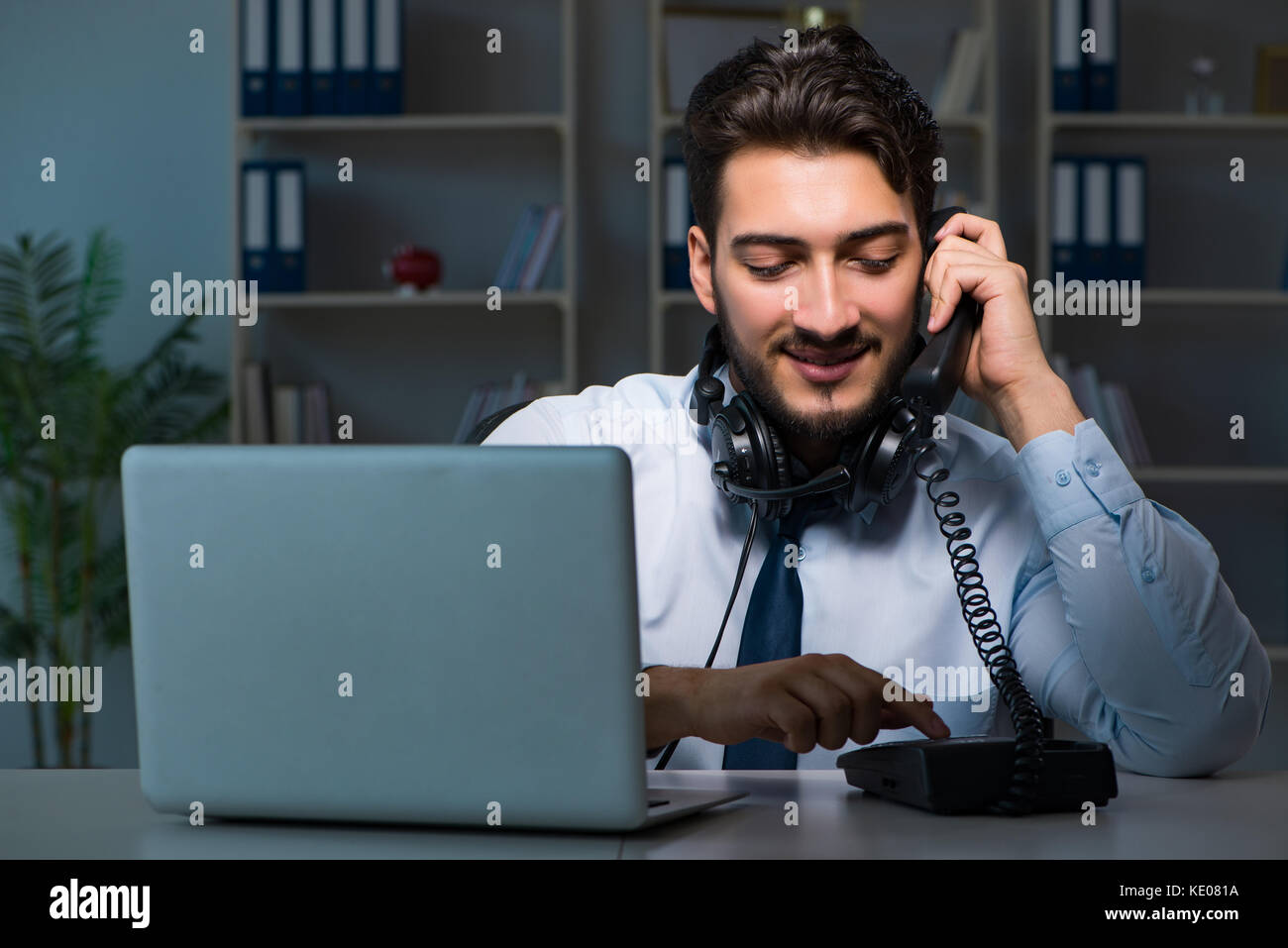 Young man in call center concept working late overtime in office Stock ...