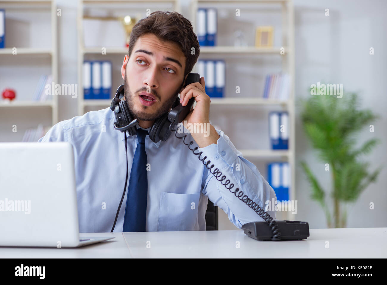 Call center employee working in office Stock Photo - Alamy