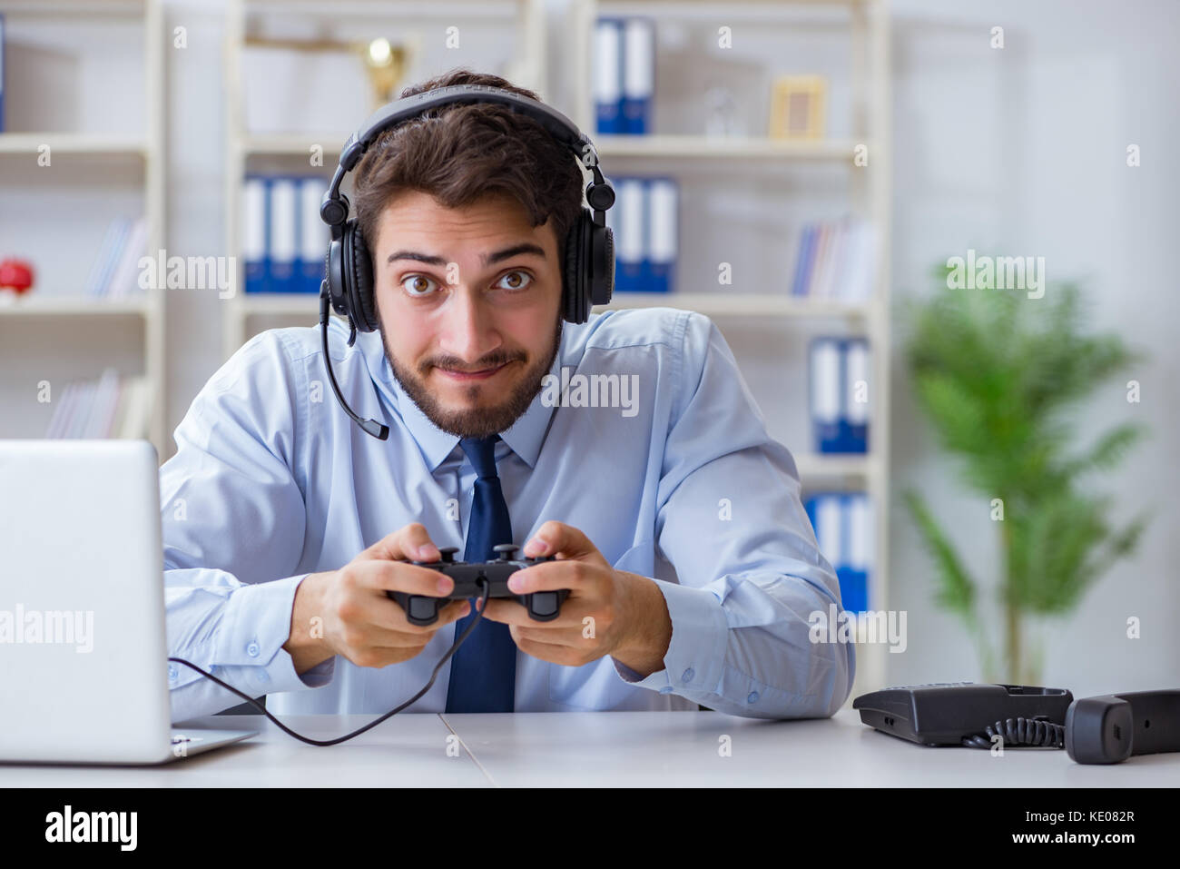 Businessman gamer in office playing games Stock Photo - Alamy