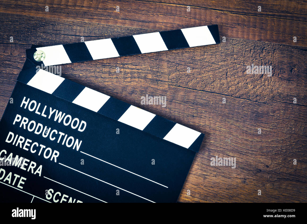 Opened clapper board or slate film on wooden background Stock Photo - Alamy