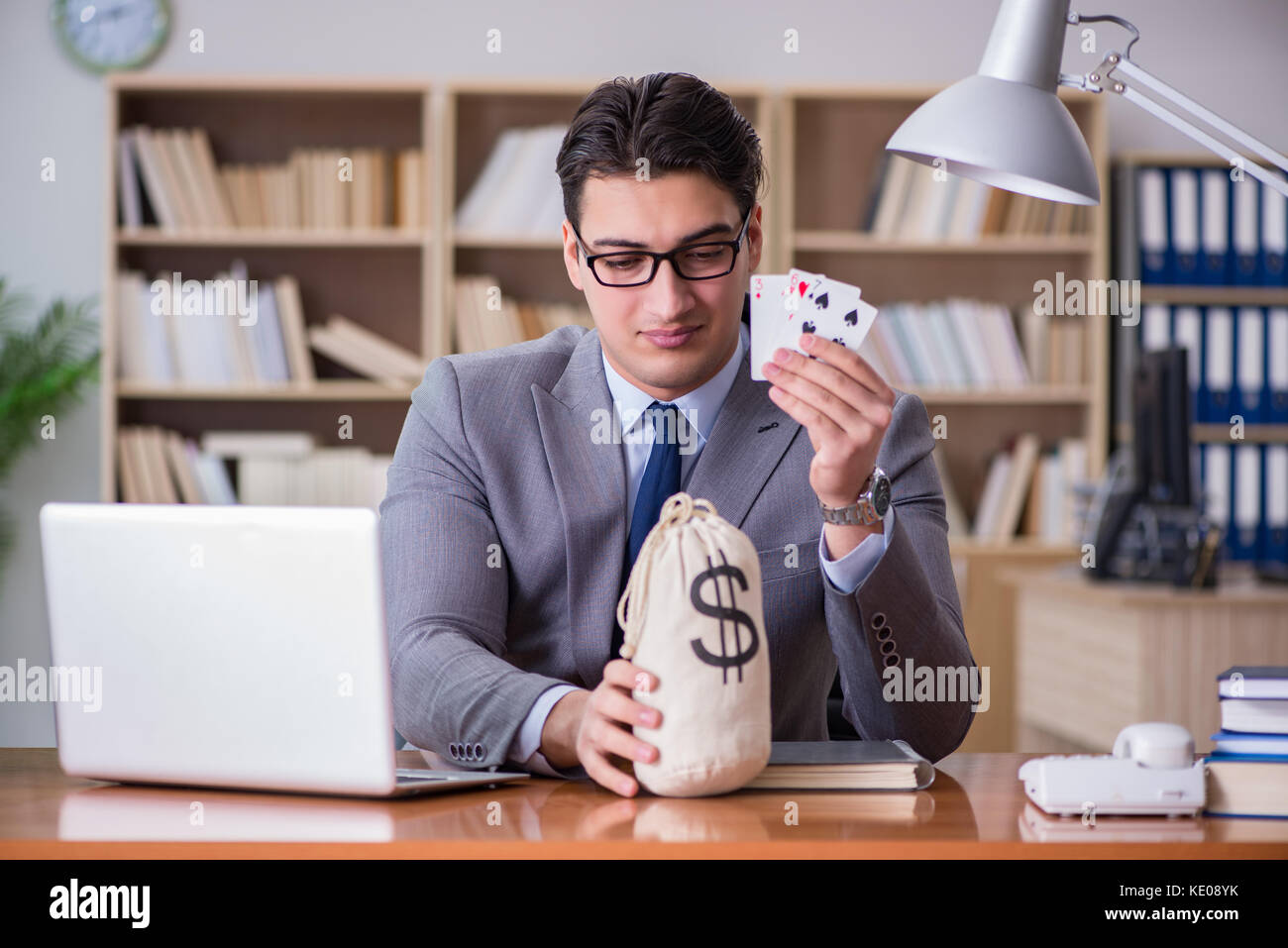 Businessman gambling playing cards at work Stock Photo - Alamy