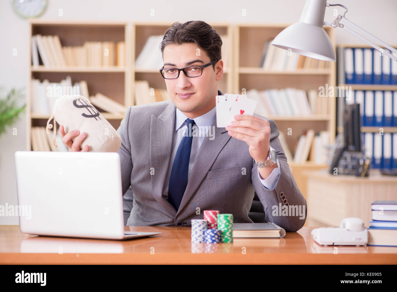 Businessman gambling playing cards at work Stock Photo - Alamy