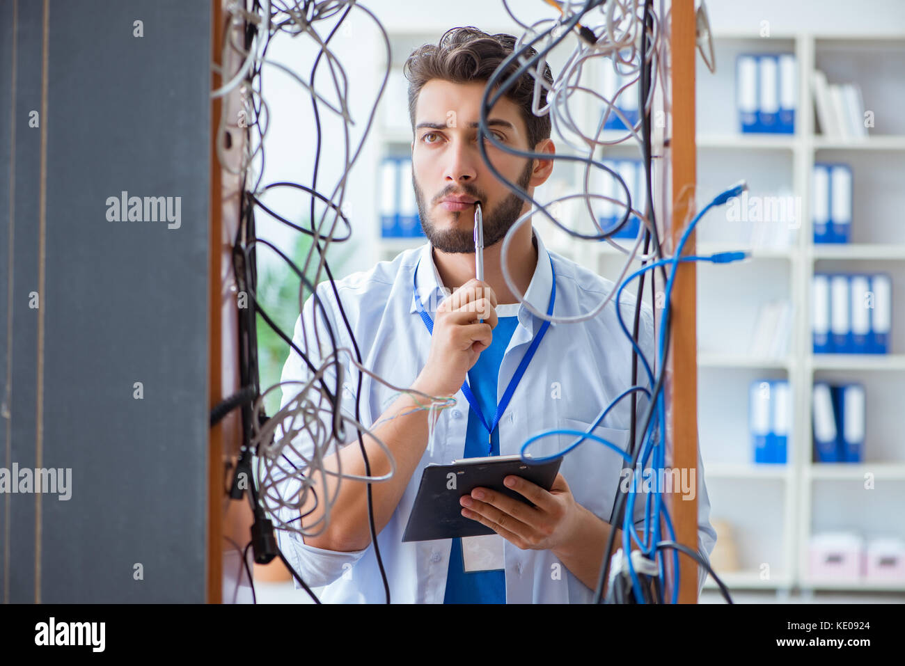Electrician trying to untangle wires in repair concept Stock Photo - Alamy