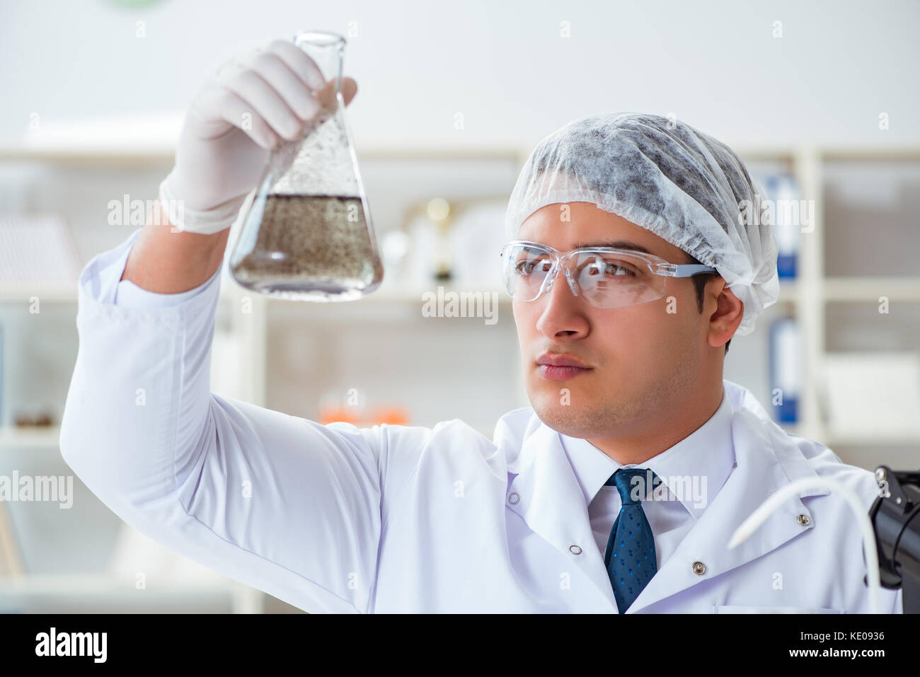 Young researcher scientist doing a water test contamination experiment ...