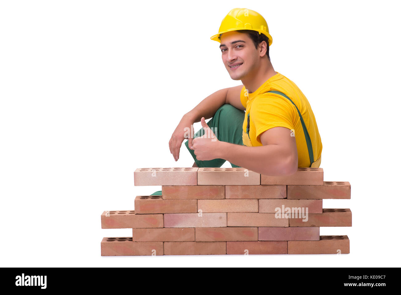 The handsome construction worker building brick wall Stock Photo - Alamy