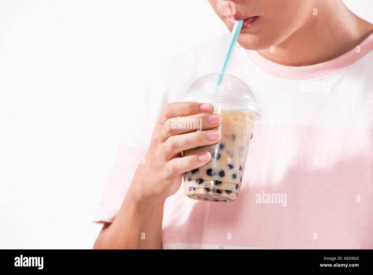 Drinking light brown creamy bubble tea and black tapioca pearls in ...