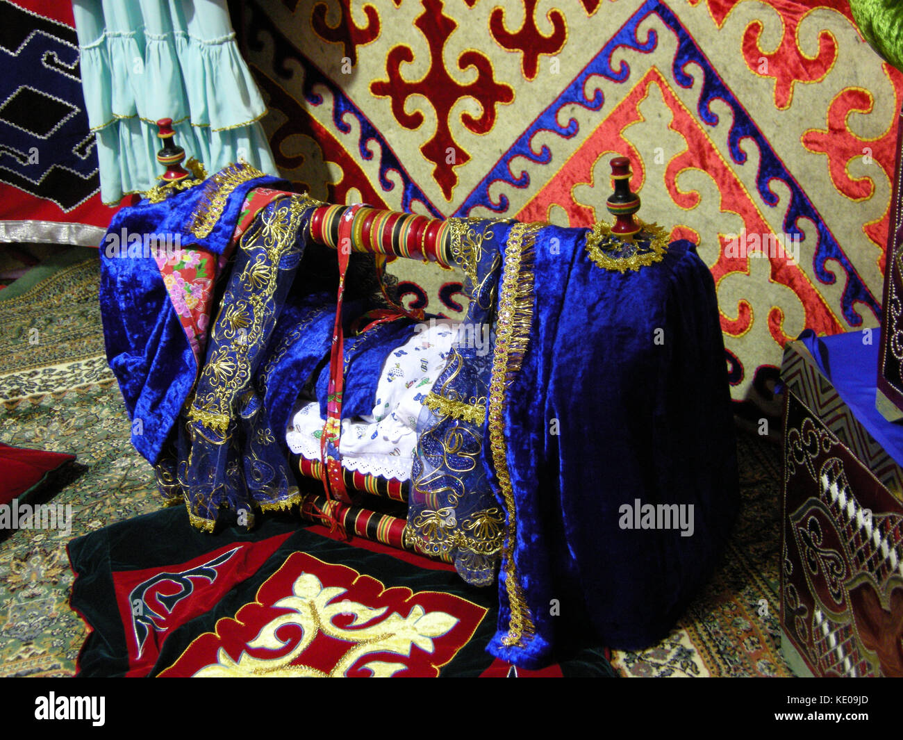 A colourfully decorated baby’s crib on display at an exhibit in the ...