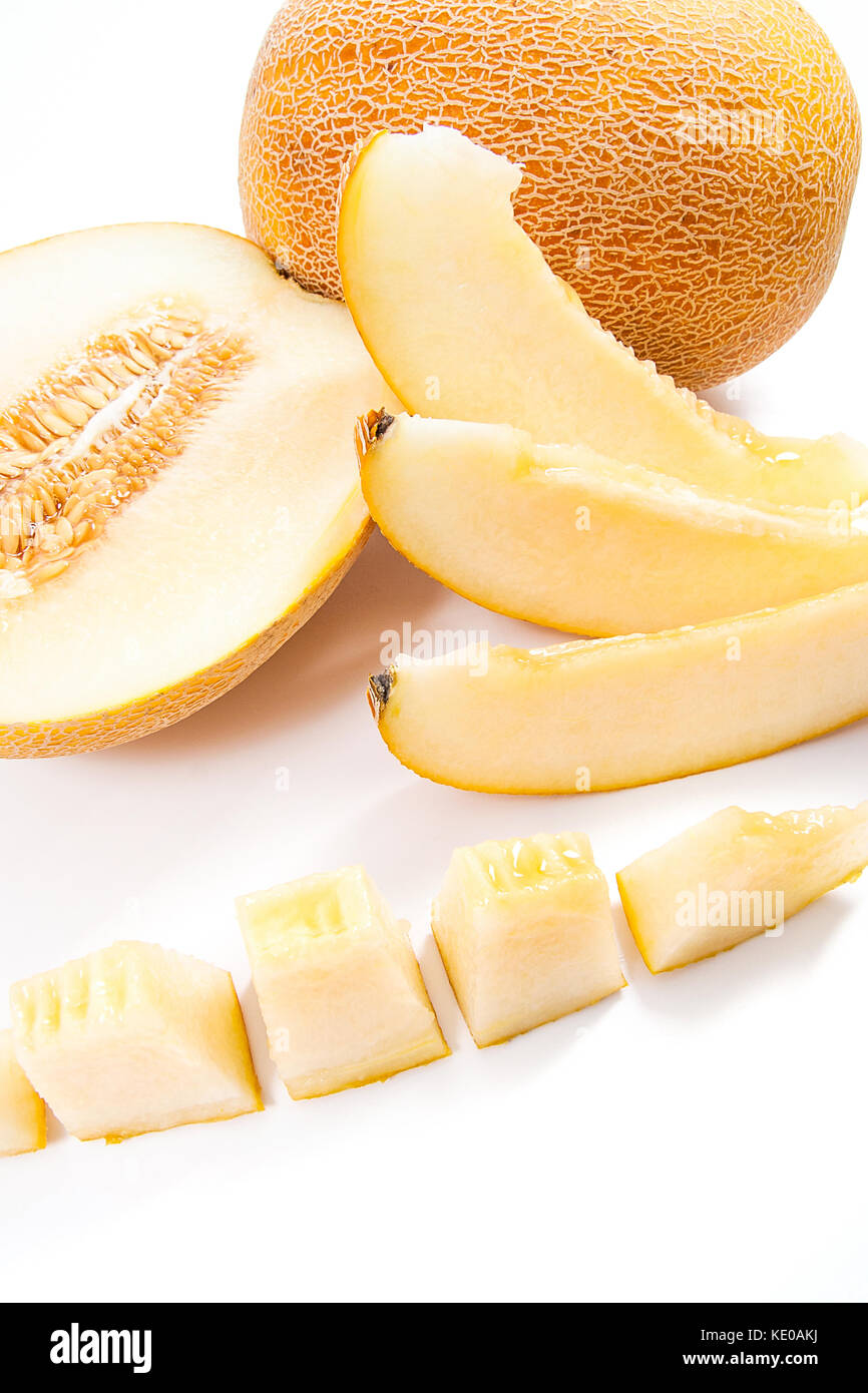 Close up view of whole, half and sliced ripe juicy melon tropical fruit ...