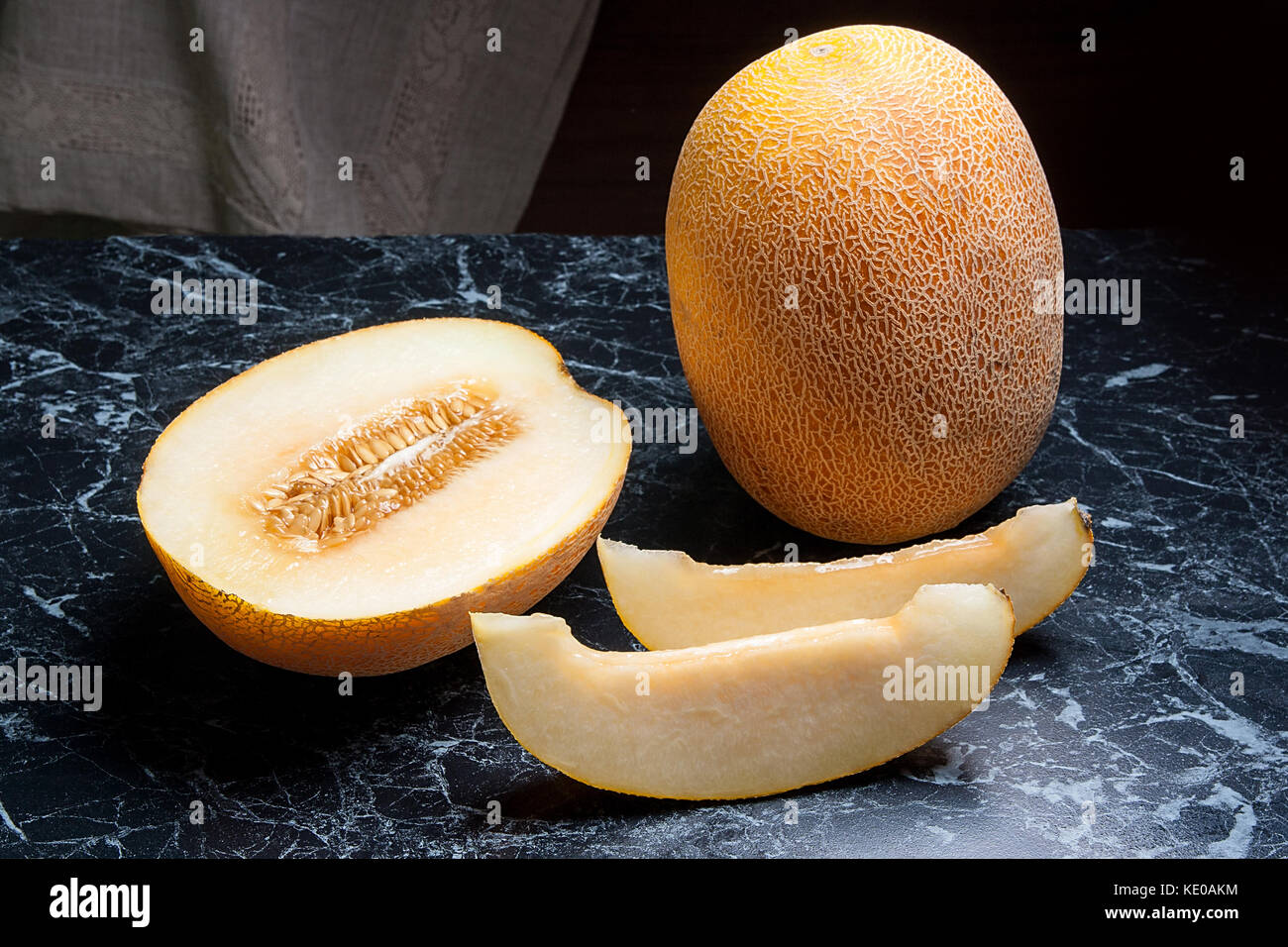 Ripe whole and half honeydew melon fruit at summer time. Sliced ripe ...