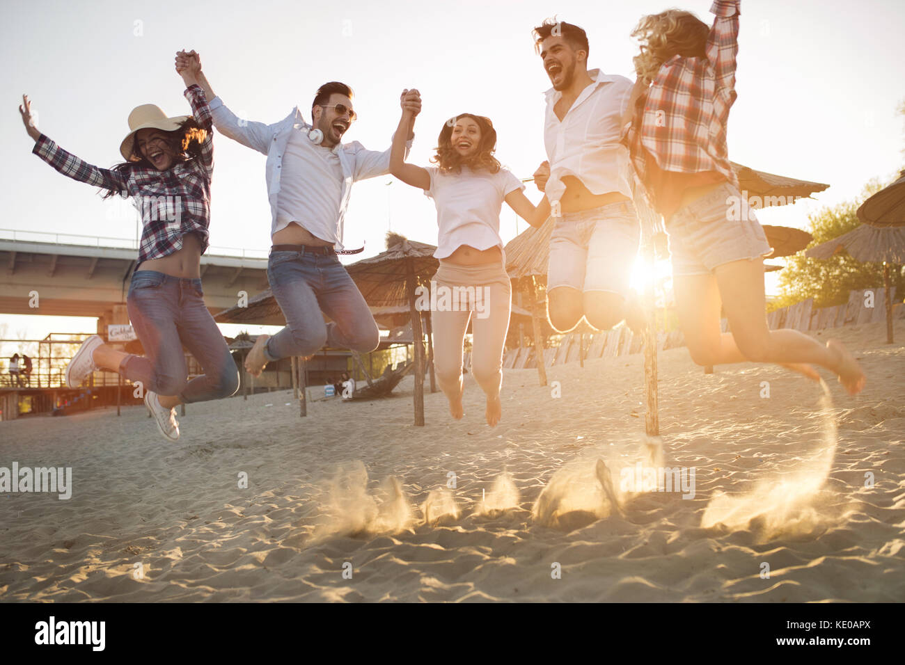 Group of friends on beach having fun Stock Photo - Alamy