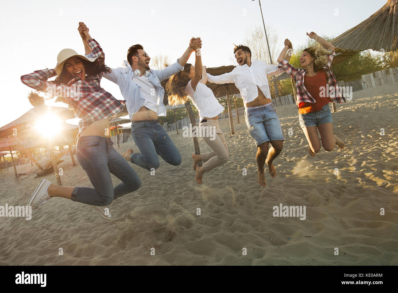 Group of friends on beach having fun Stock Photo - Alamy