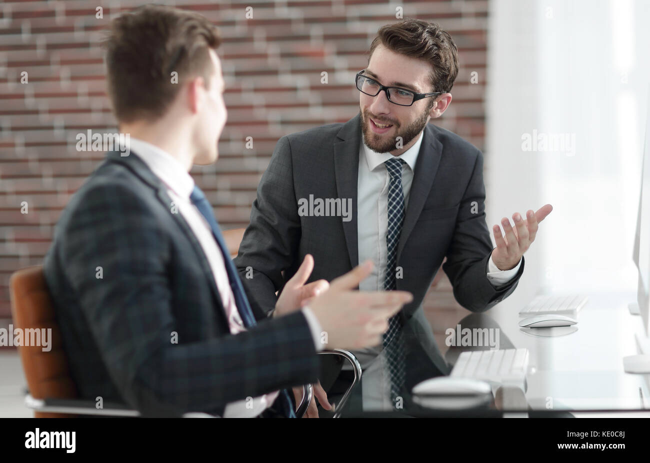 Manager talking with a colleague Stock Photo - Alamy