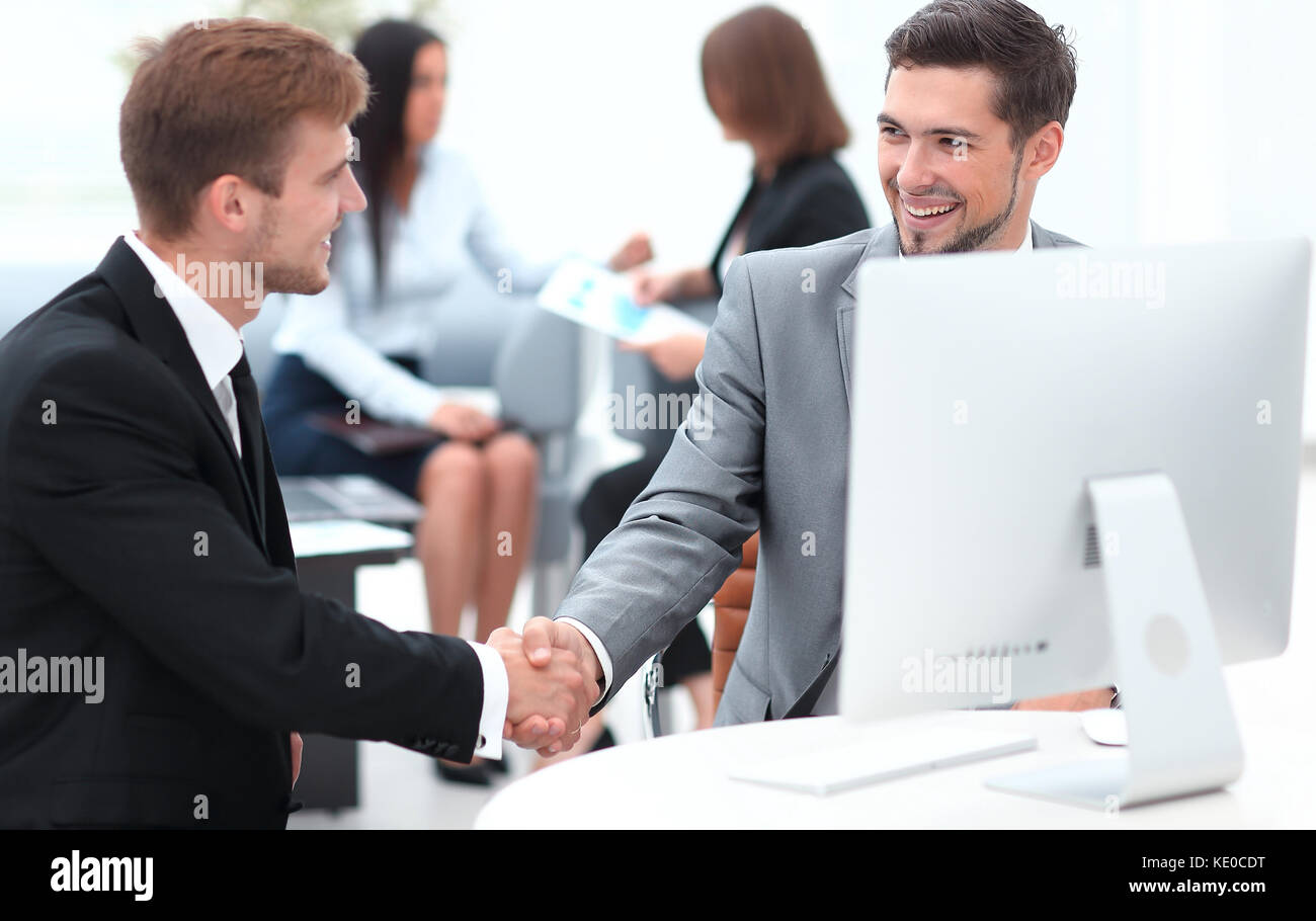 handshake Manager and the client in the office Stock Photo - Alamy