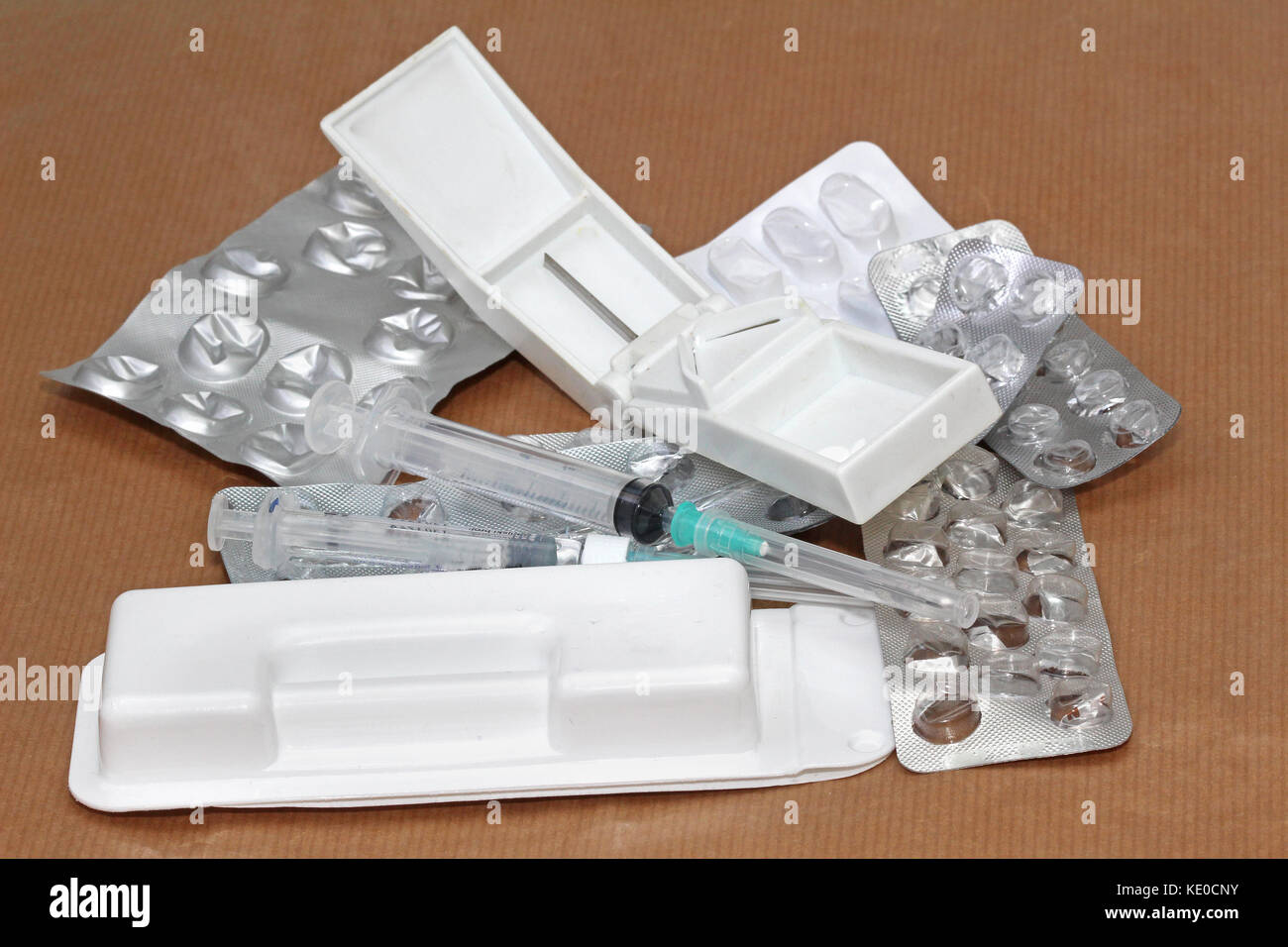 Pile of used medicines packages syringes and tablet cutter Stock Photo ...