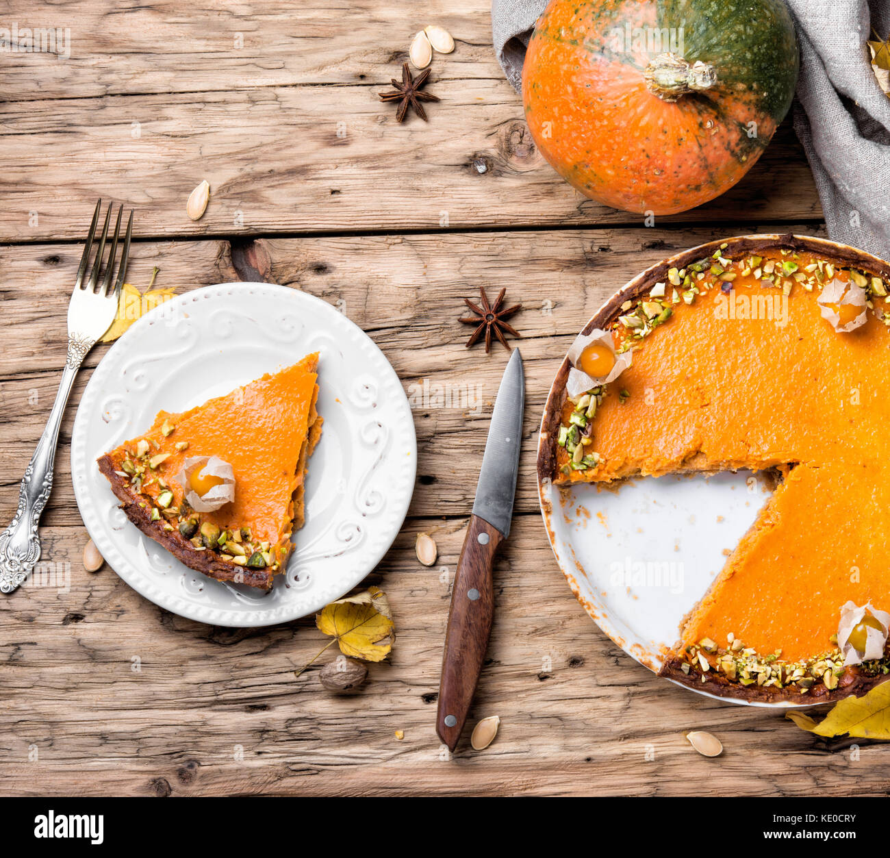 rustic autumn pie from a pumpkin on a wooden background Stock Photo - Alamy