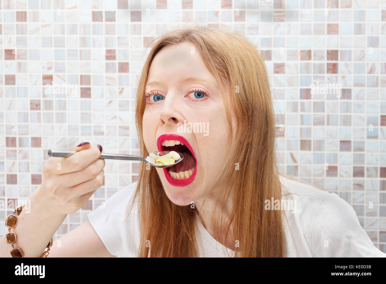 Young girl with prescription drugs addiction eating full spoon of ...