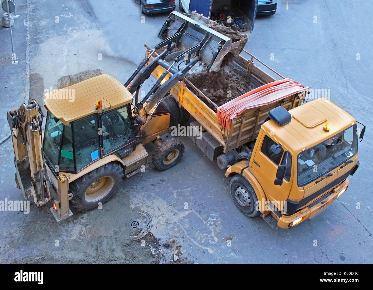 Digging road works on small street with industrial machines Stock Photo ...