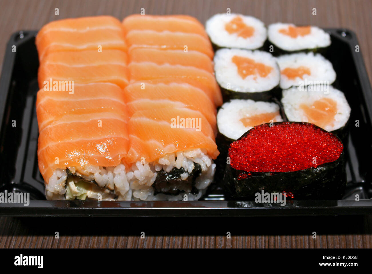 Assortment of fresh sushi on plastic plate Stock Photo - Alamy