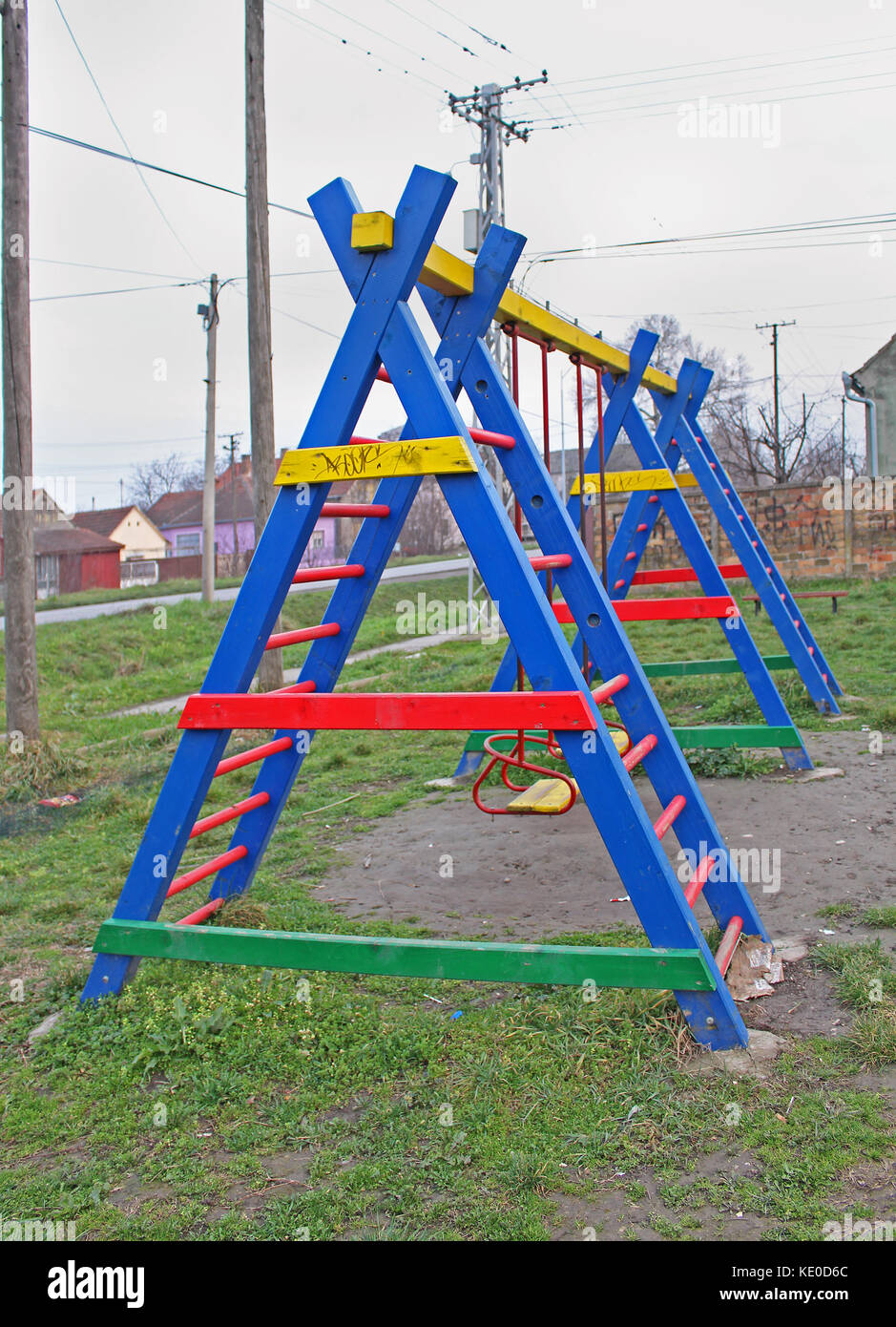 Colorful child playground with swing on rural field Stock Photo - Alamy