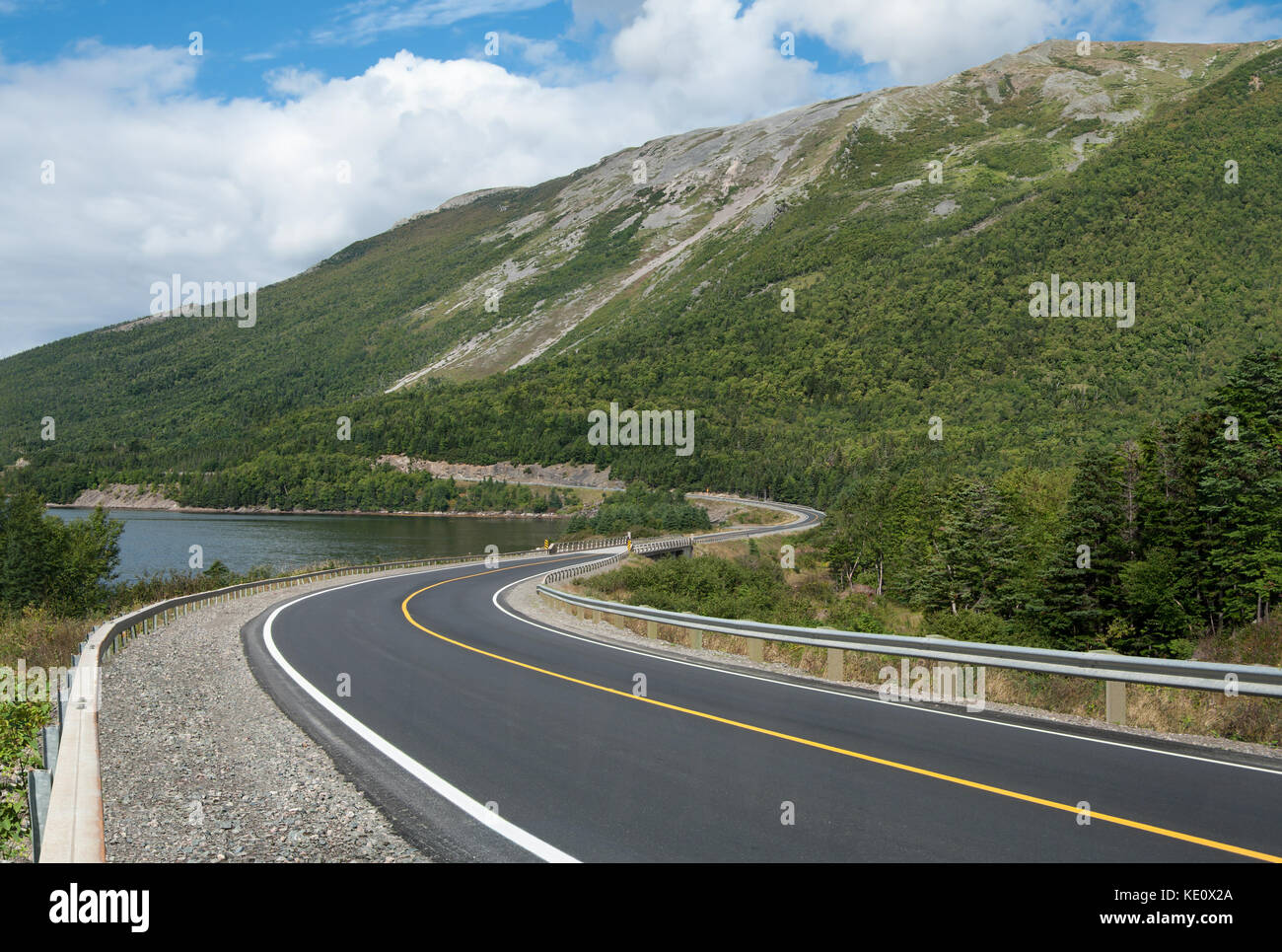 Scenic Road in Newfoundland: A two-lane highway curves past an ocean ...