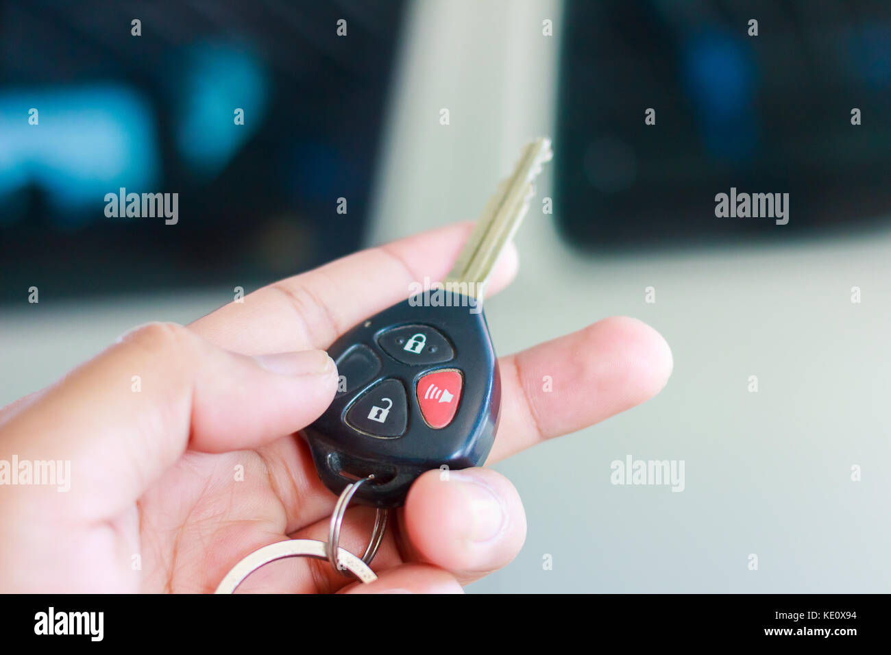 hand presses on the remote control car alarm systems Stock Photo - Alamy