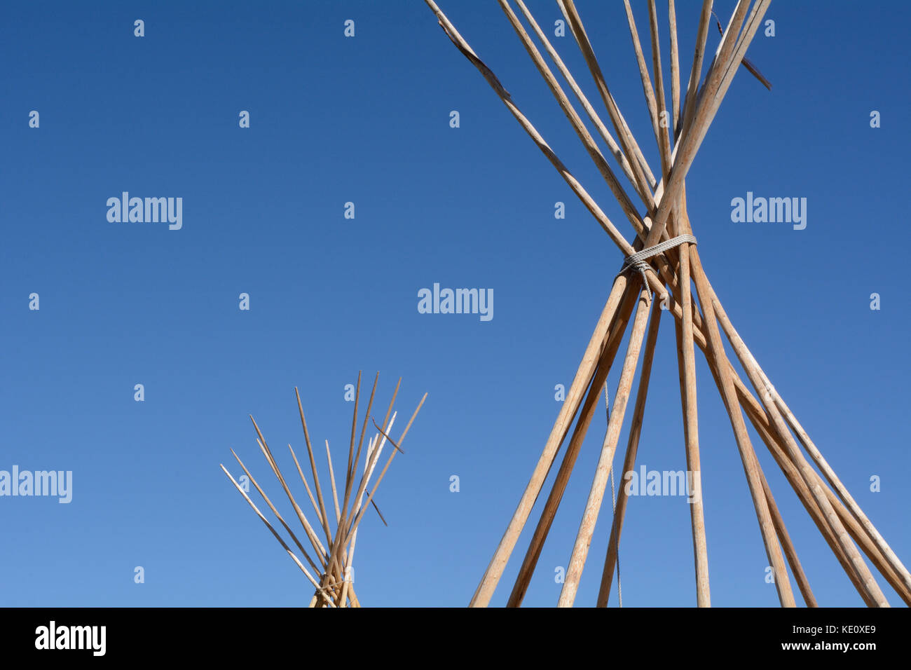 Bare winter teepee poles at end of camping season Stock Photo - Alamy