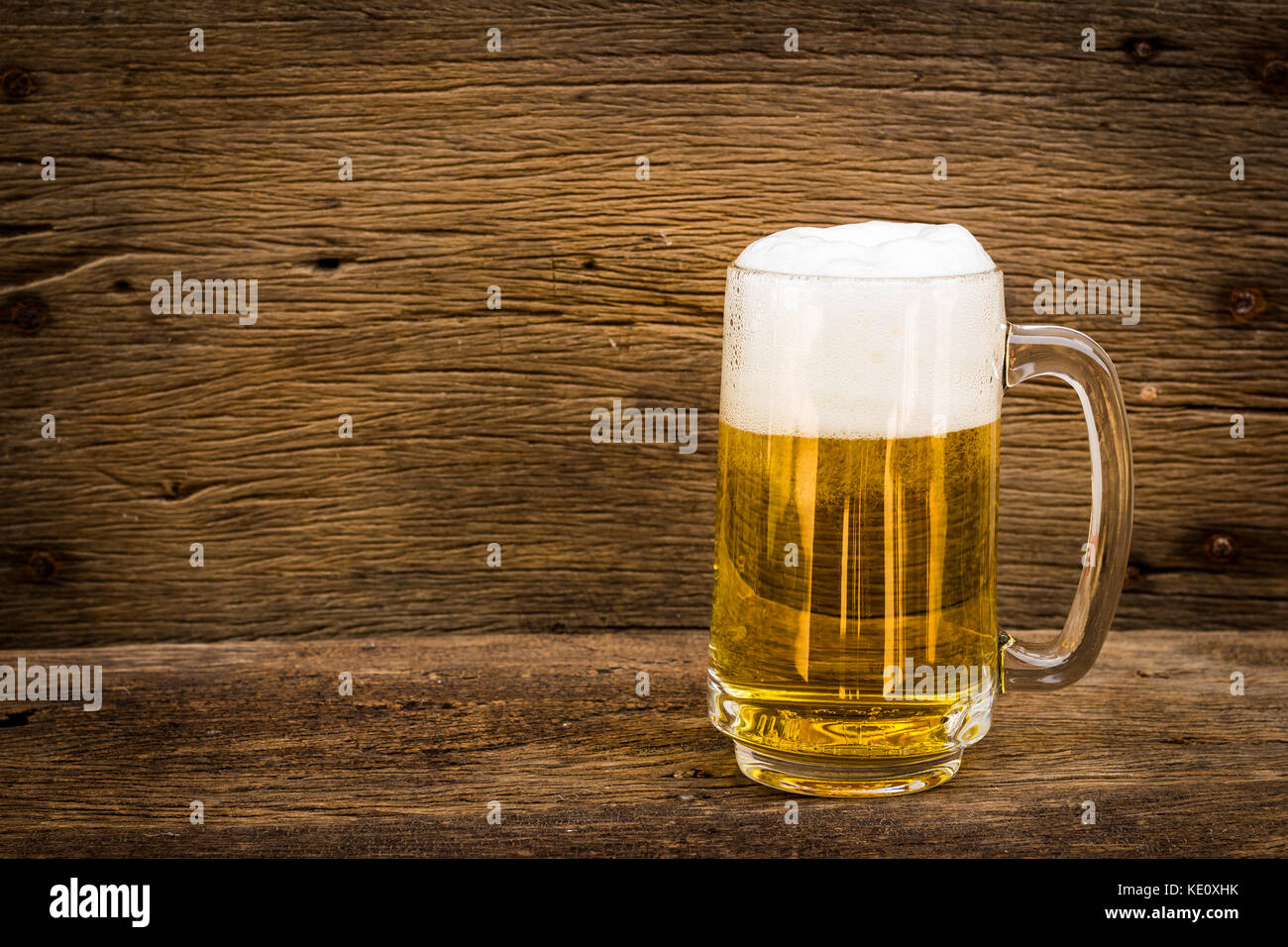 Beer in glass on wood table Stock Photo - Alamy
