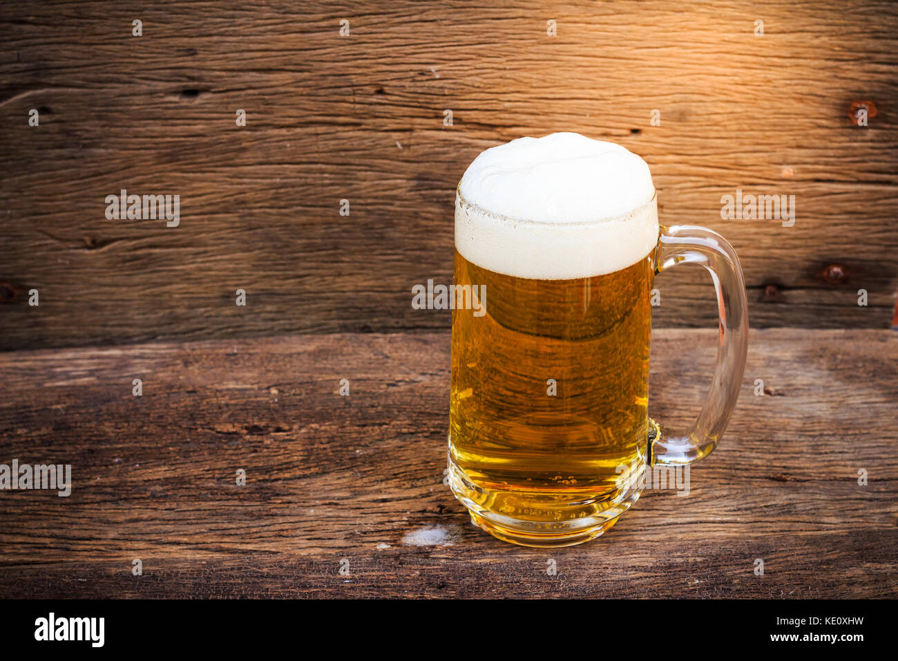 Beer in glass on wood table Stock Photo - Alamy