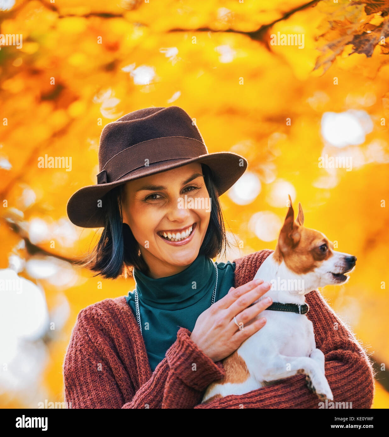 Portrait of happy young woman dog outdoors in autumn Stock Photo - Alamy