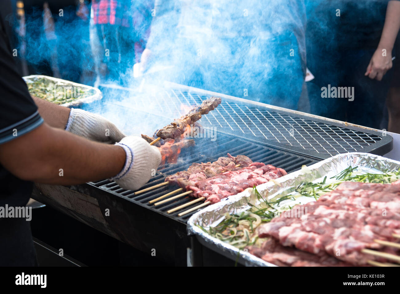 Grilled meat at street food market Stock Photo - Alamy