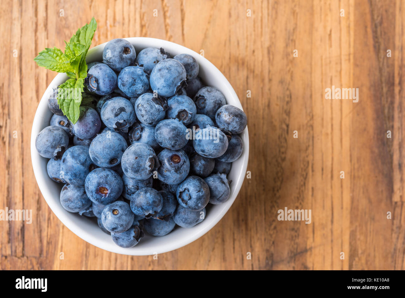 fresh blueberry on a wooden table and bowl Stock Photo - Alamy