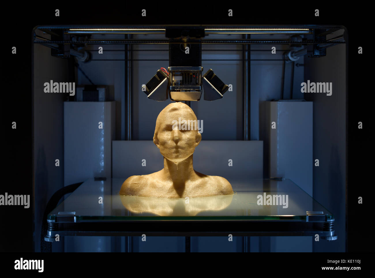 3D printer printing a female bust with golden PLA filament, Polylactide ...