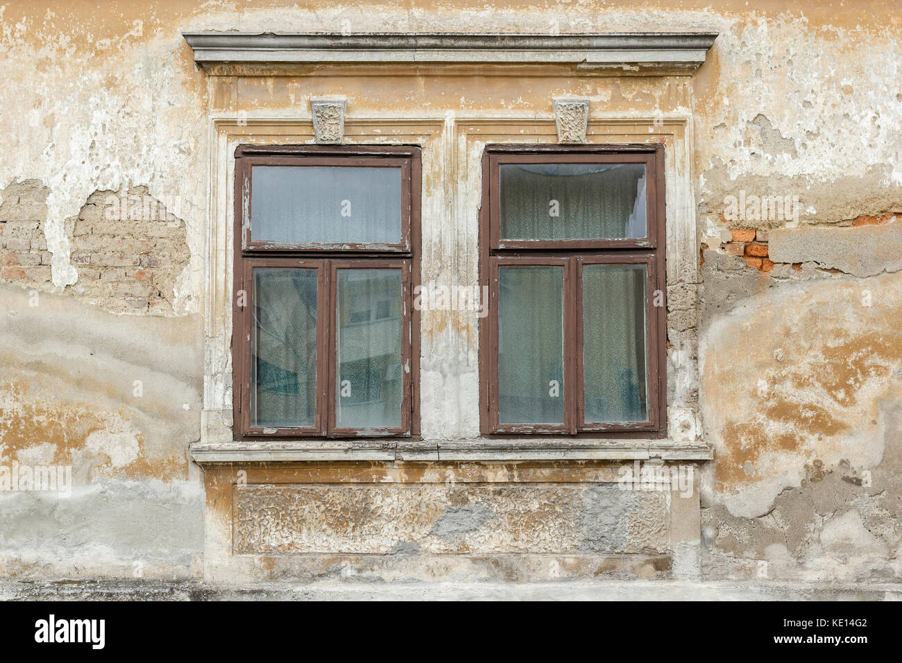 Two old broken windows on an abandoned old building Stock Photo - Alamy
