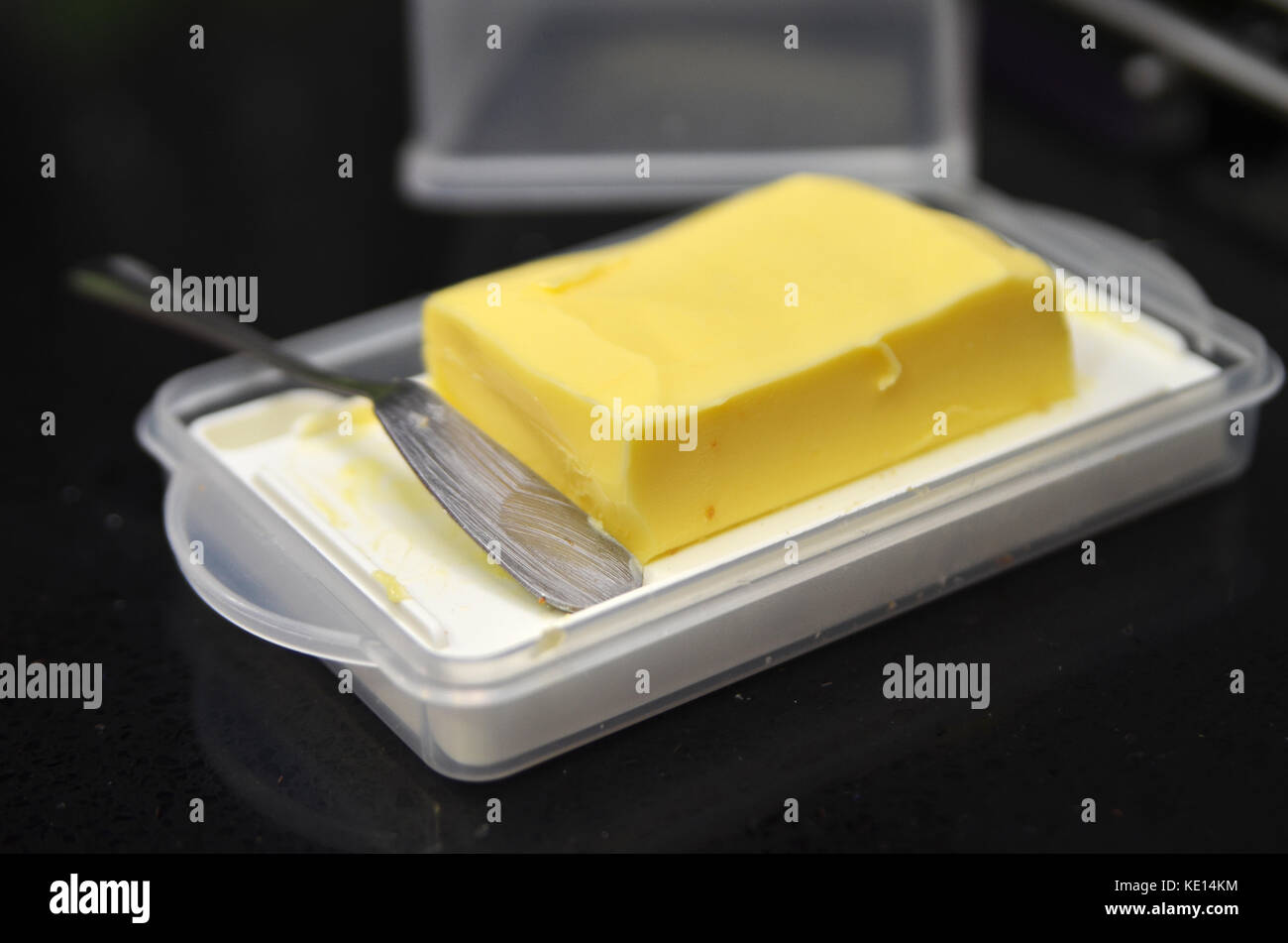 Butter cube on the black table in kitchen Stock Photo - Alamy