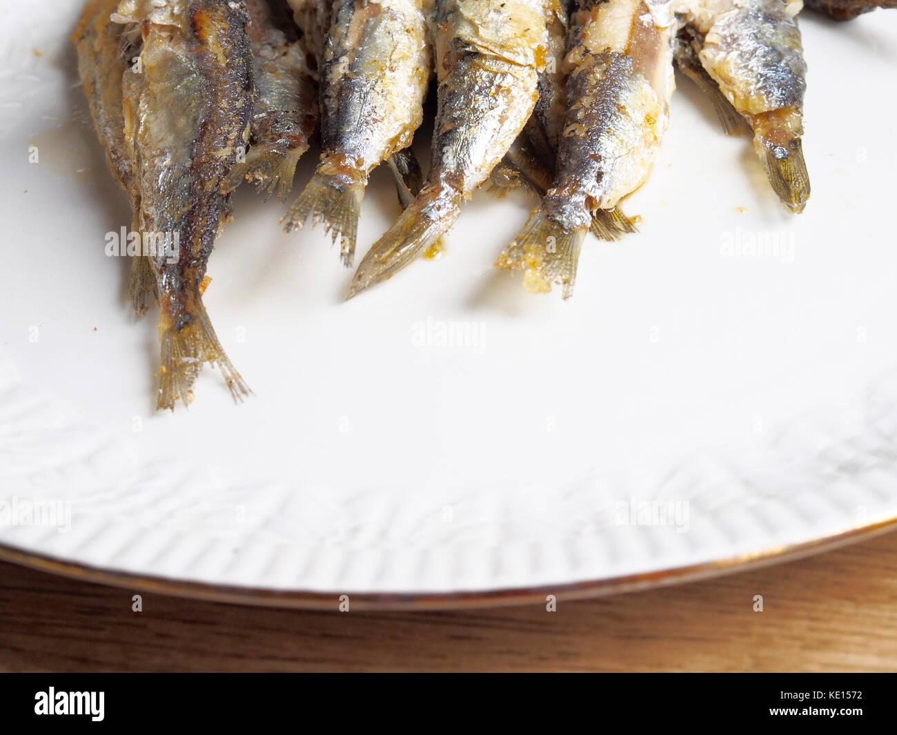 Fried small sardine on a plate Stock Photo - Alamy